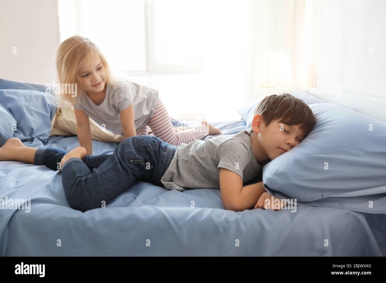 Cute children on bed at home. Family bedtime Stock Photo - Alamy