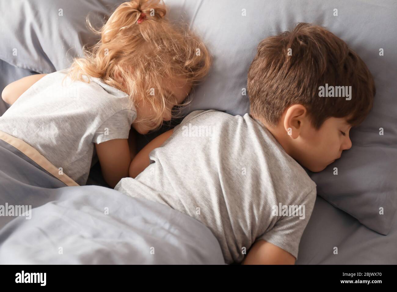 Cute little children sleeping in bed at home. Family bedtime Stock ...
