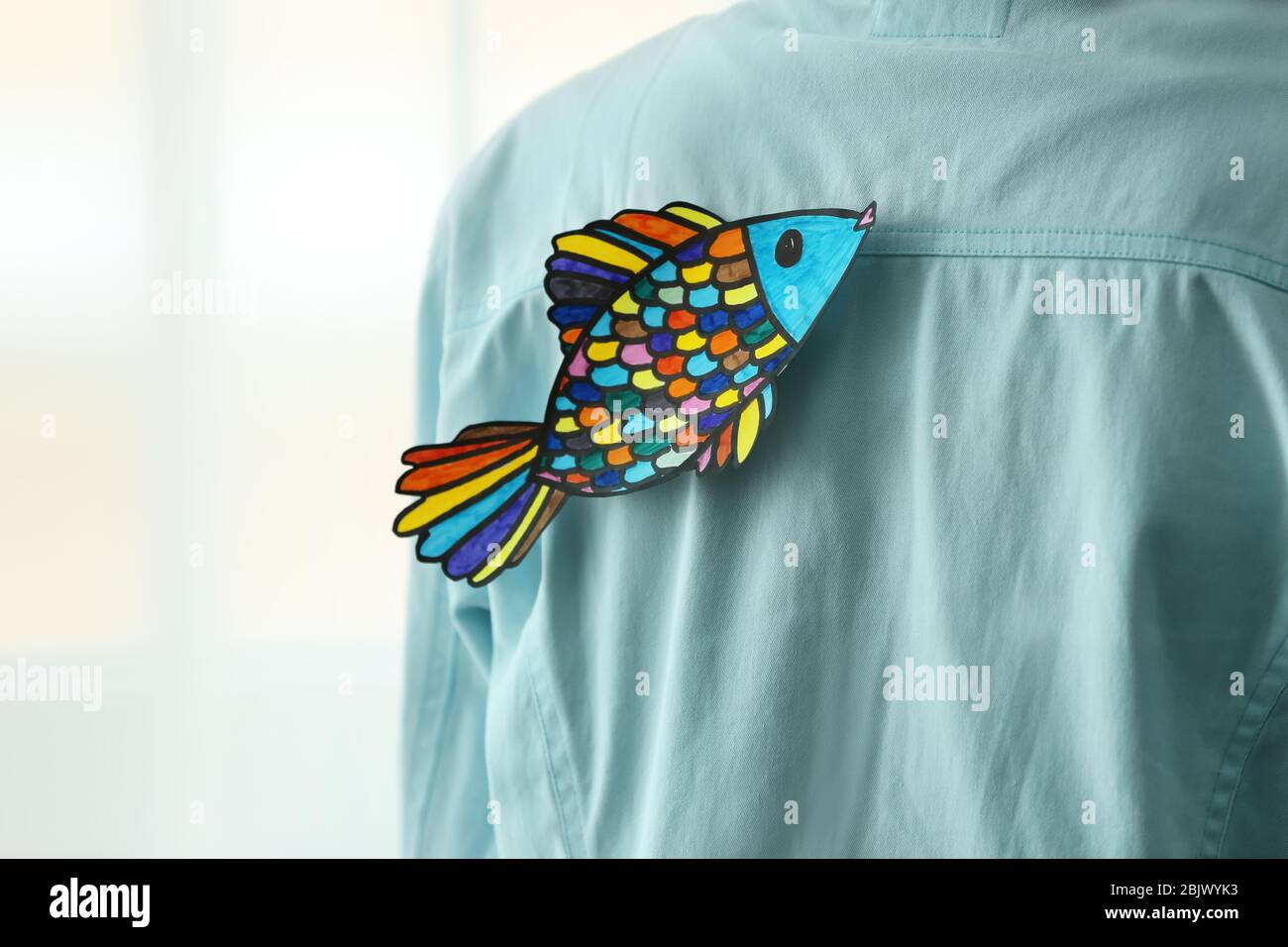 Paper fish on man's back, closeup. April fool's day prank Stock Photo ...