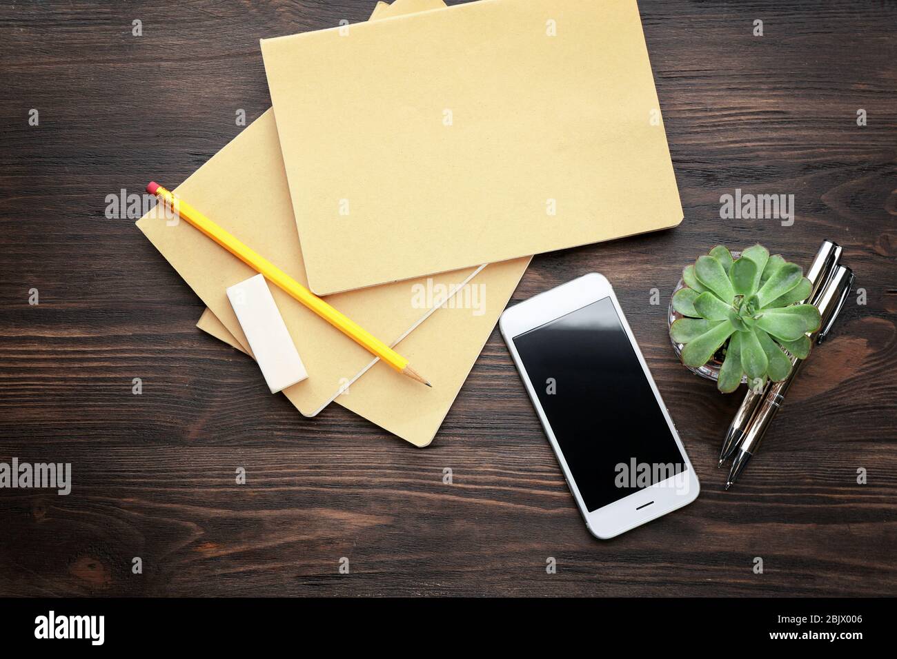 Office stationery and phone on table Stock Photo - Alamy