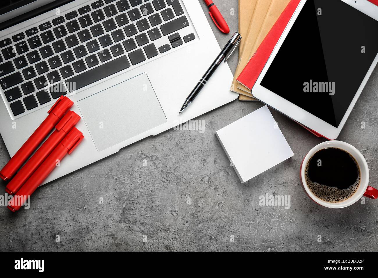 Office stationery with laptop, cup of coffee and tablet on table Stock ...