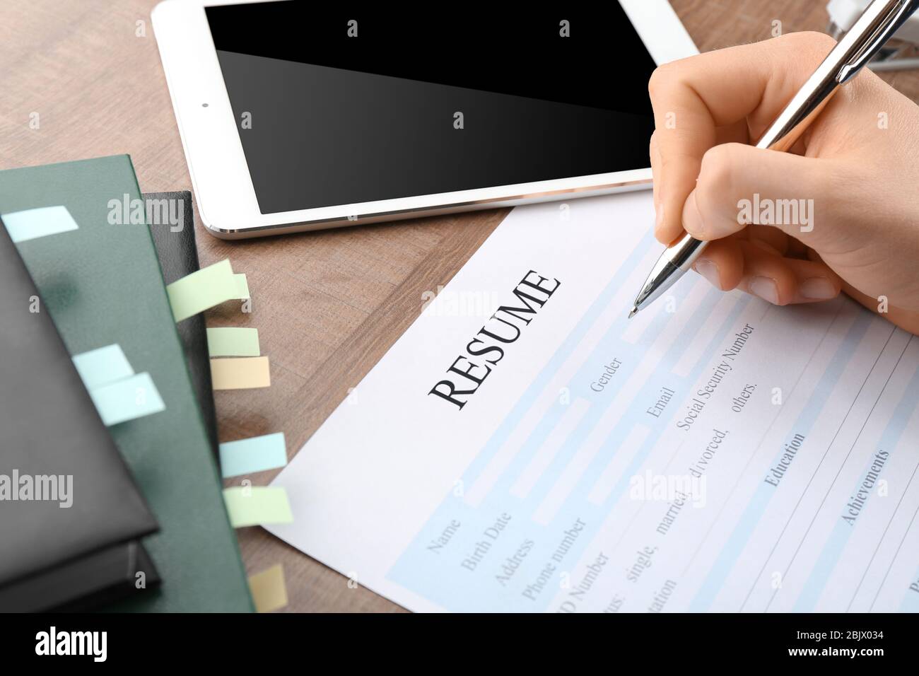Woman filling in resume form at table. Job interview concept Stock ...