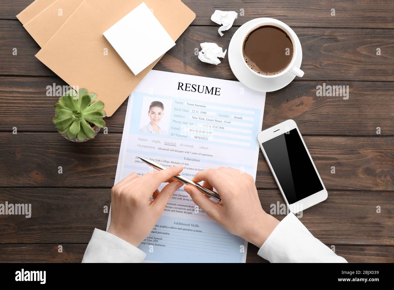 Woman with resume form at table. Job interview concept Stock Photo - Alamy