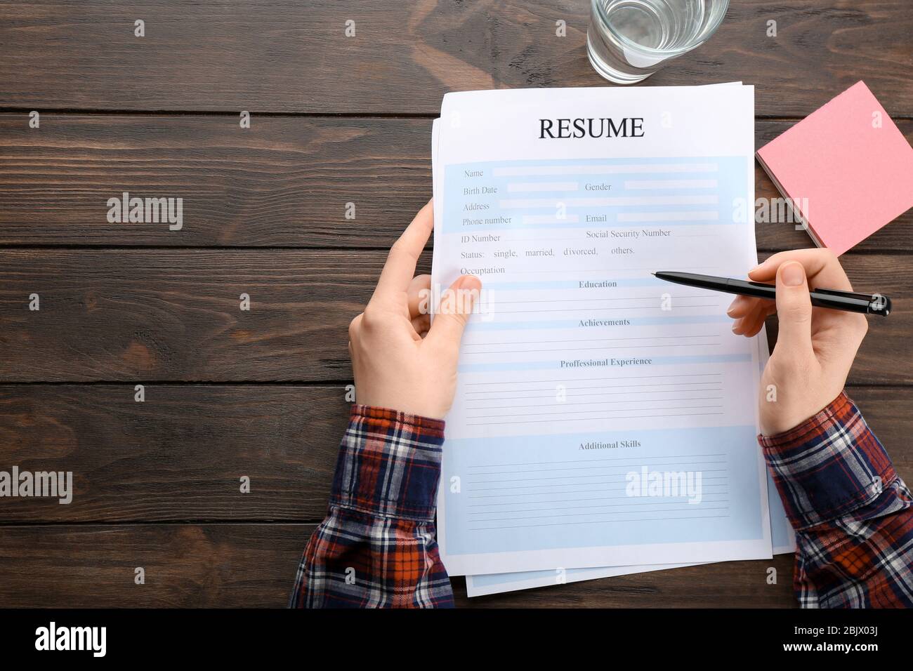 Woman filling in resume form at table. Job interview concept Stock ...