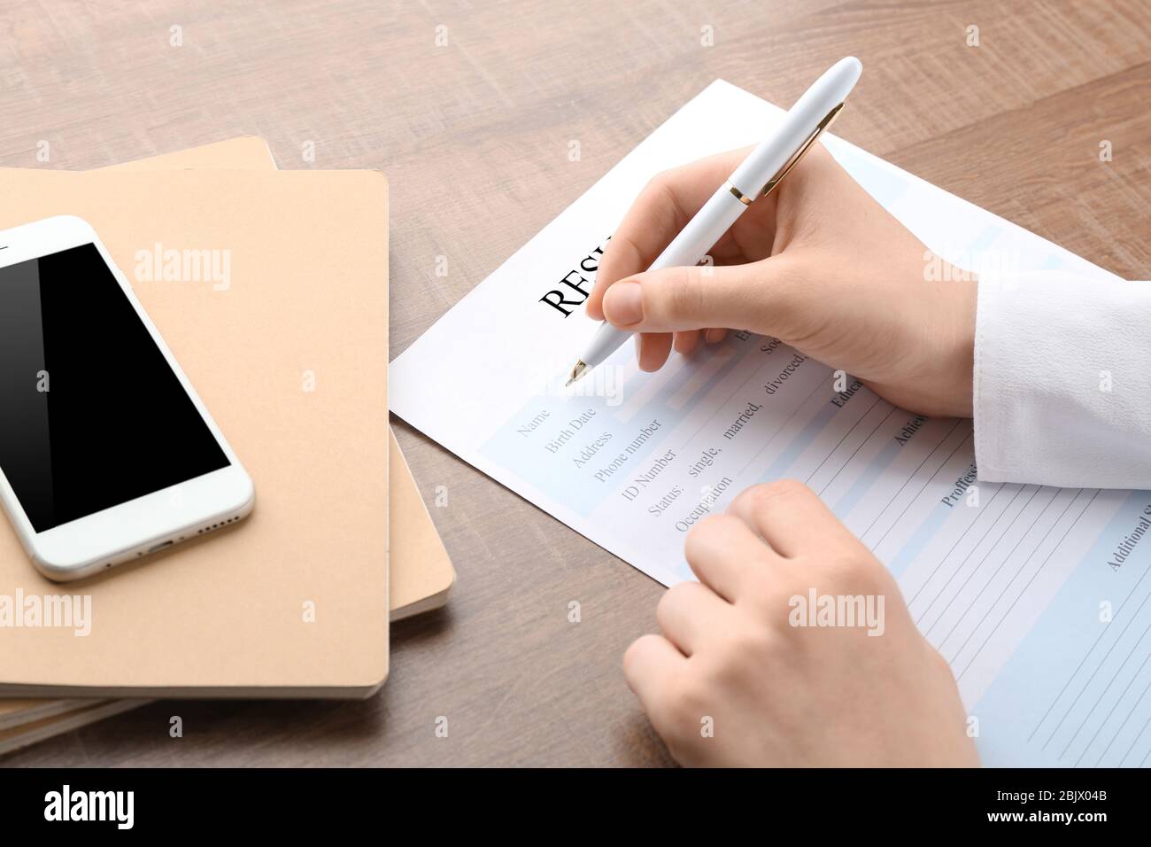 Woman filling in resume form at table. Job interview concept Stock ...