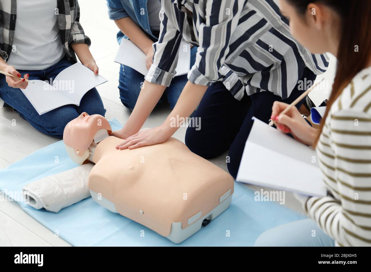 Group of people practicing CPR on mannequin at first aid class Stock ...