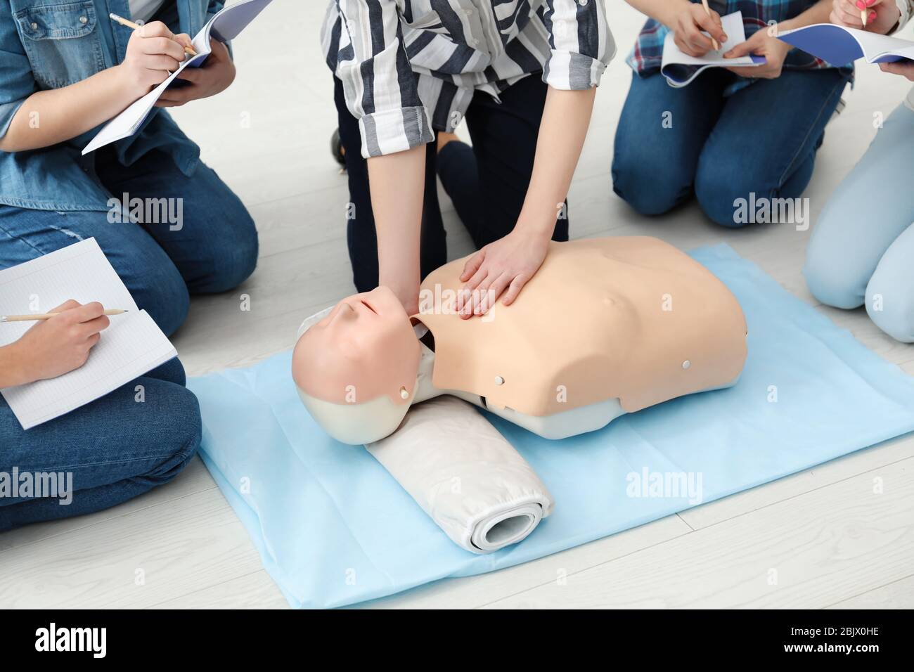 Group of people practicing CPR on mannequin at first aid class Stock ...