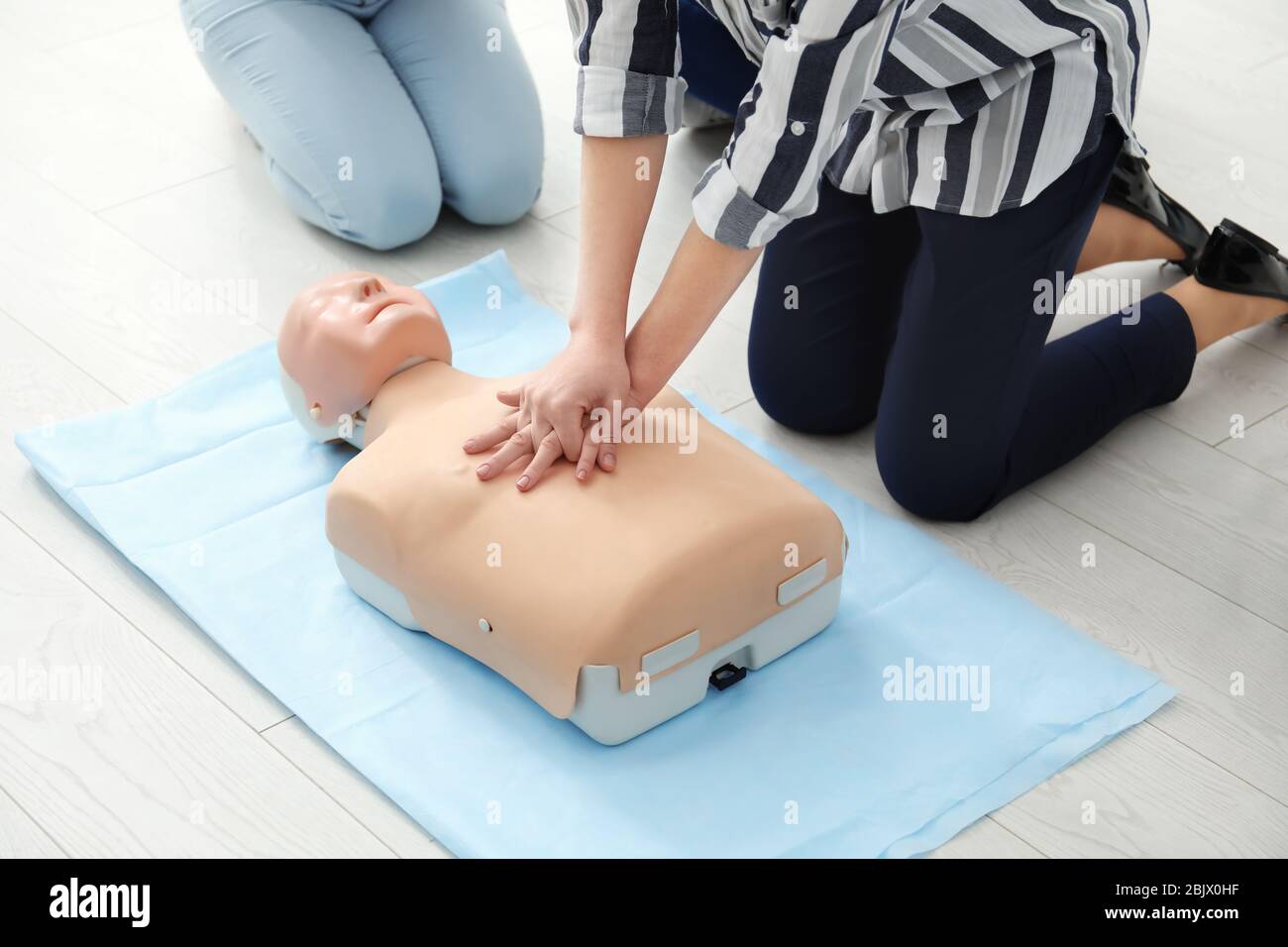 Group of people practicing CPR on mannequin at first aid class Stock ...