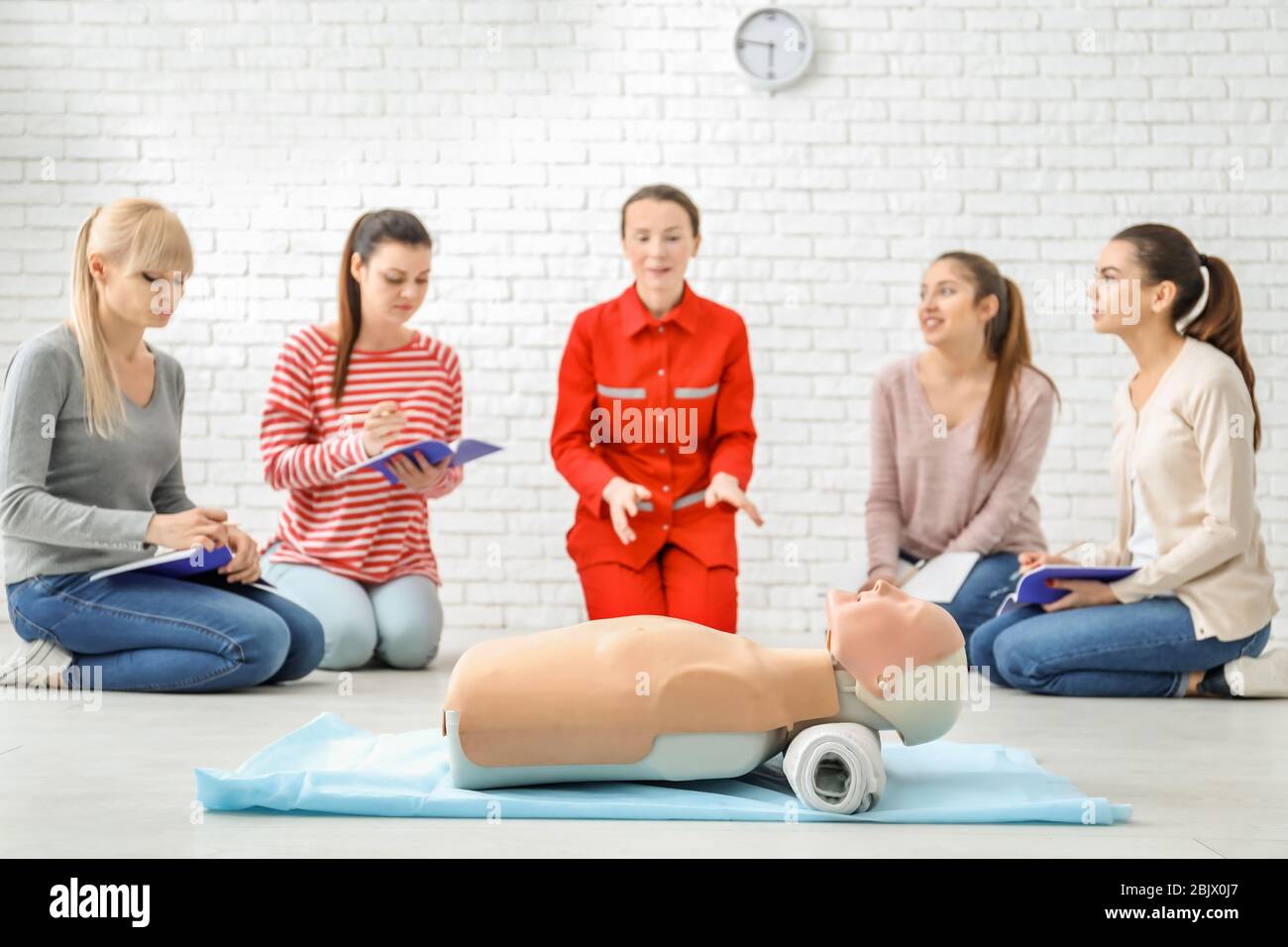 Group of people practicing CPR on mannequin at first aid class Stock ...