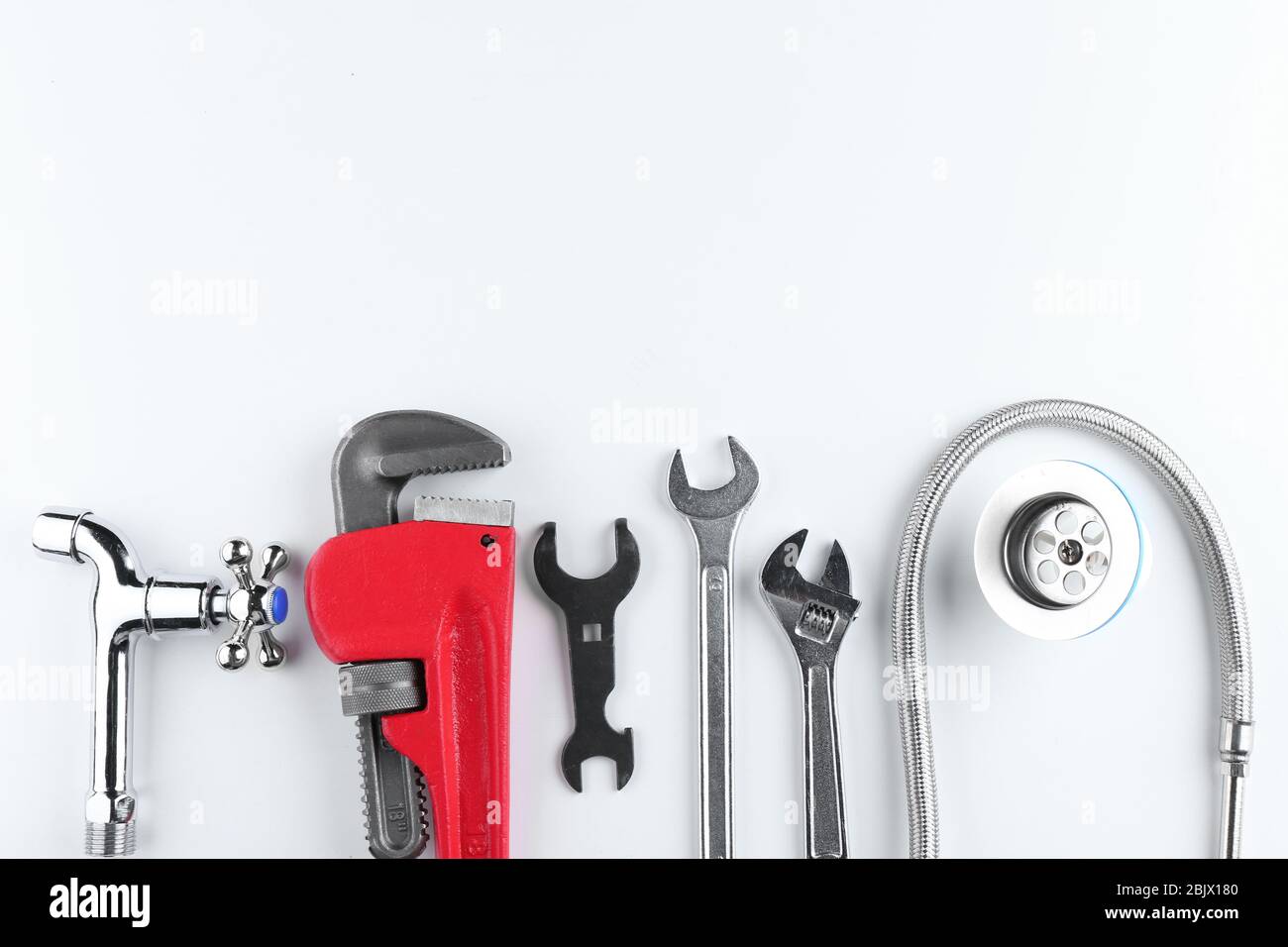 Plumber's items on white background Stock Photo - Alamy