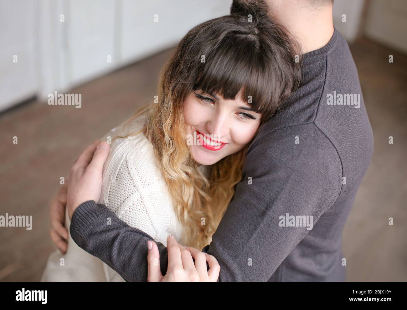 Loving woman hugging beloved hi-res stock photography and images - Alamy