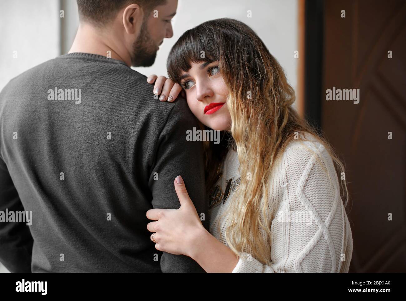 Young woman hugging her boyfriend indoors Stock Photo - Alamy Young woman hugging her boyfriend indoors Stock Photo - Alamy