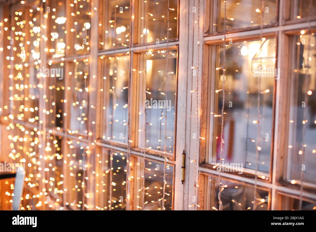 Beautiful Christmas lights on window, closeup Stock Photo - Alamy