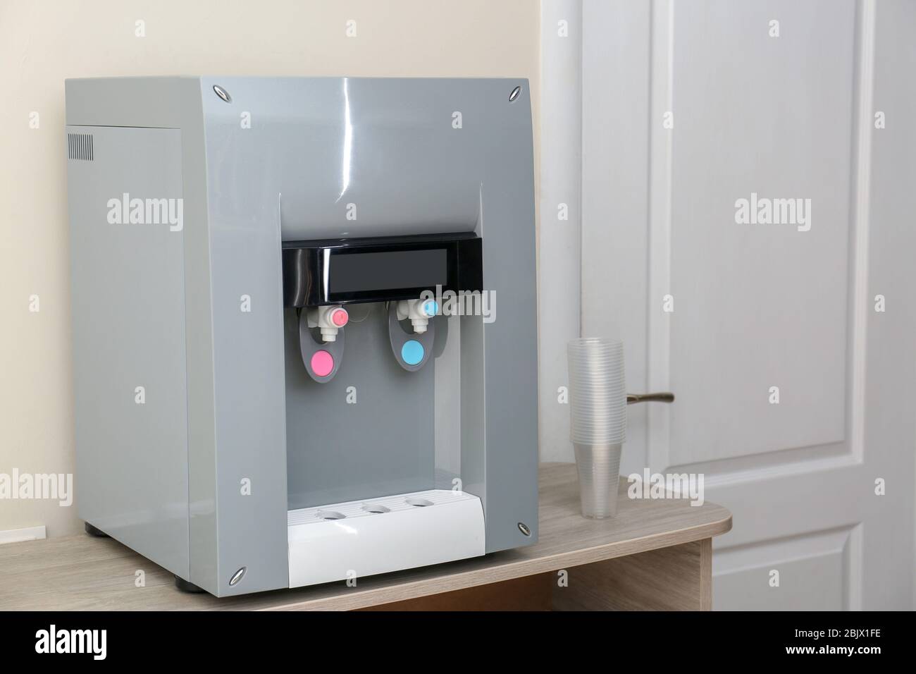 Water cooler on table indoors Stock Photo - Alamy