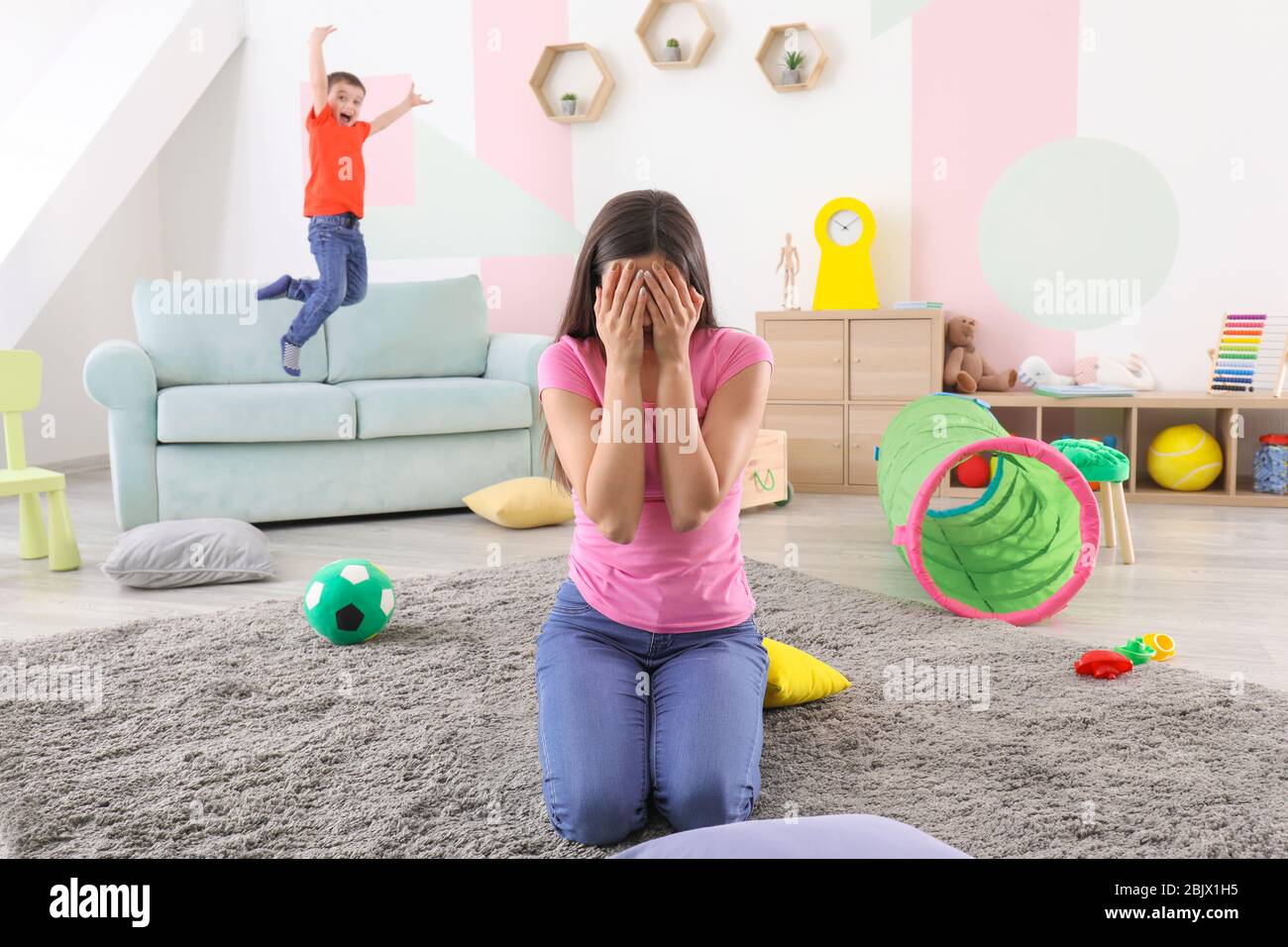 Young nanny in despair and troublesome child at home Stock Photo - Alamy