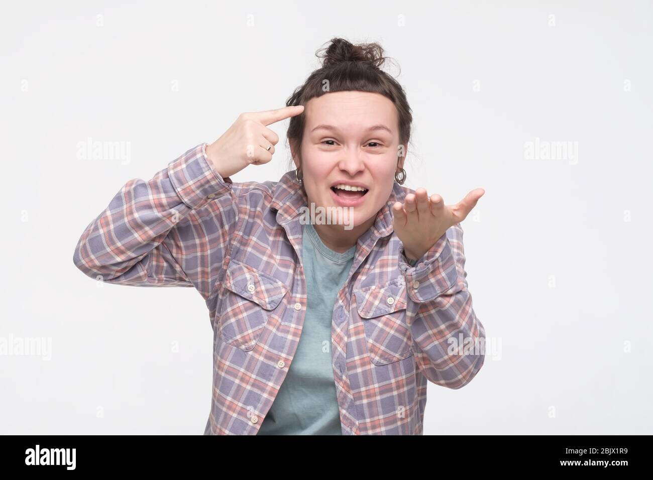 Aggressive angry teenager woman being furious. Studio shot. Negative ...