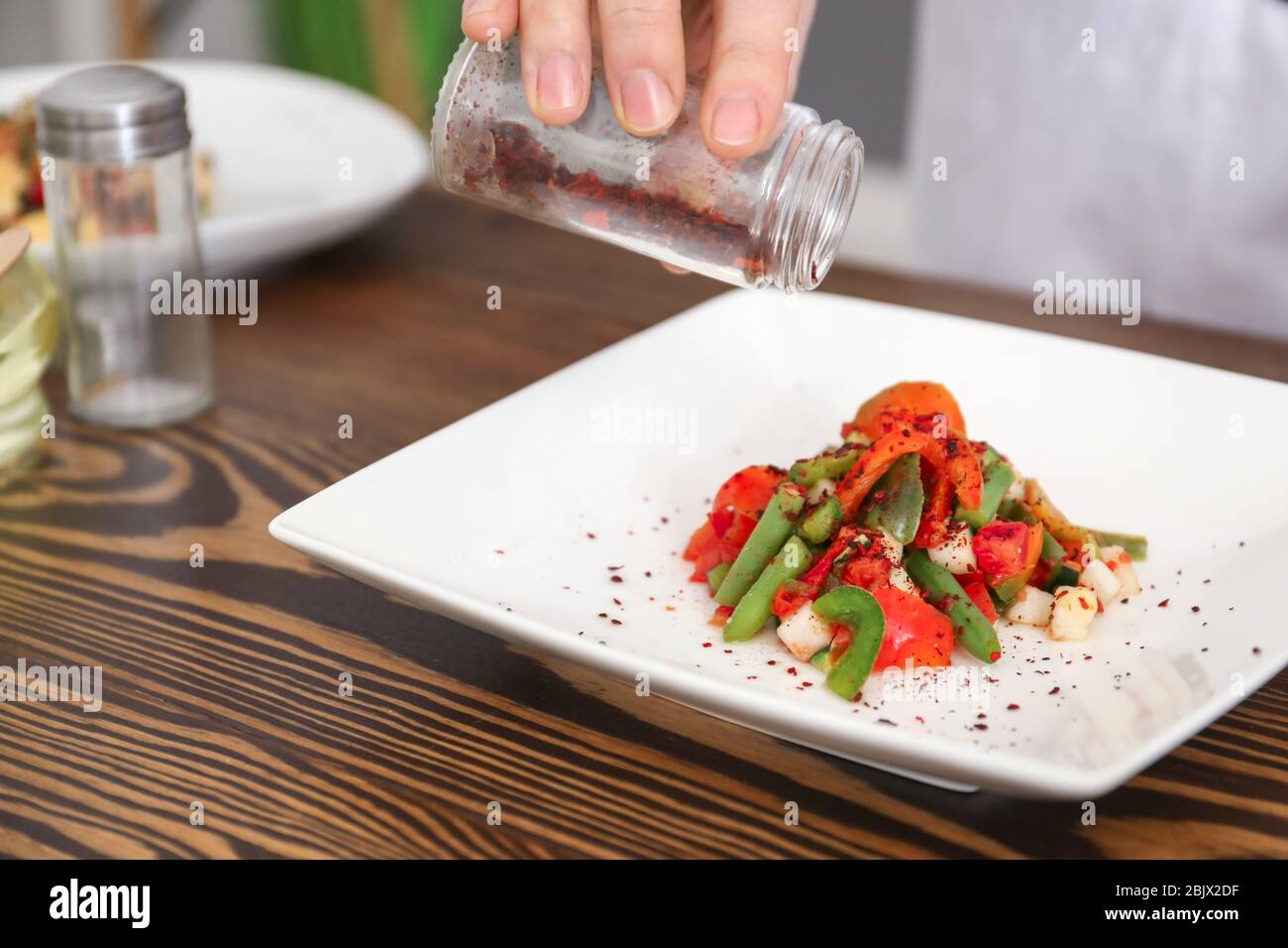 Female chef adding spices hi-res stock photography and images - Alamy