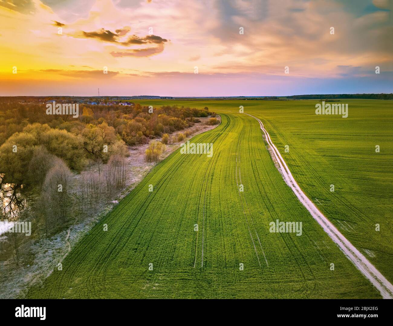 Aerial view of dirt road through landscape with meadow hi-res stock ...