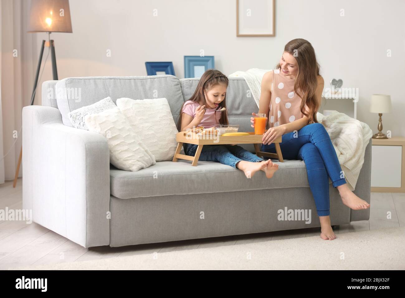 Family eating breakfast on sofa hi-res stock photography and images - Alamy