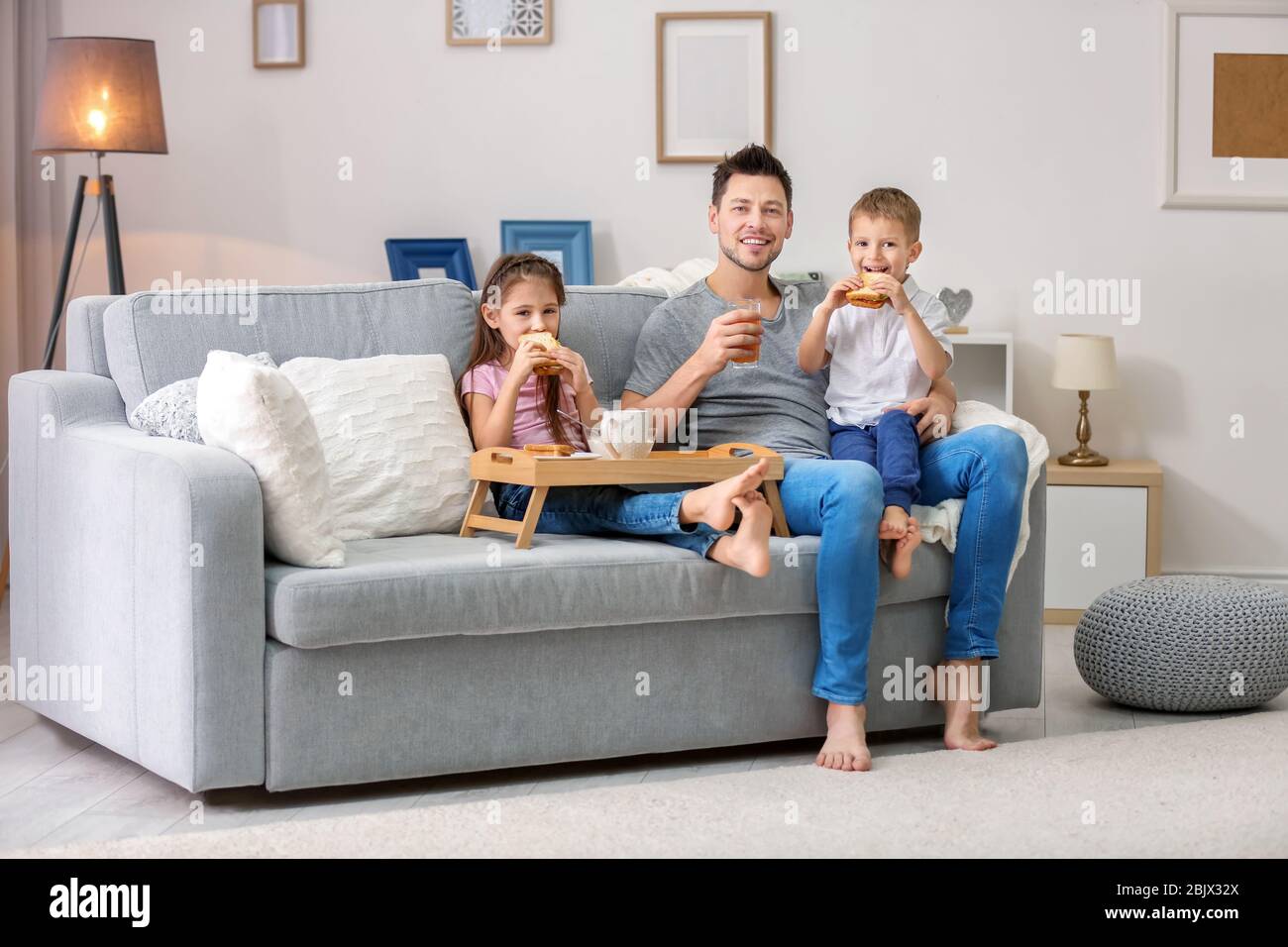 Family eating breakfast on sofa hi-res stock photography and images - Alamy