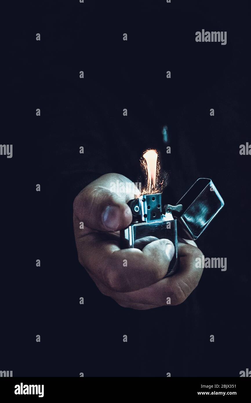A hand with a lighter on Stock Photo - Alamy