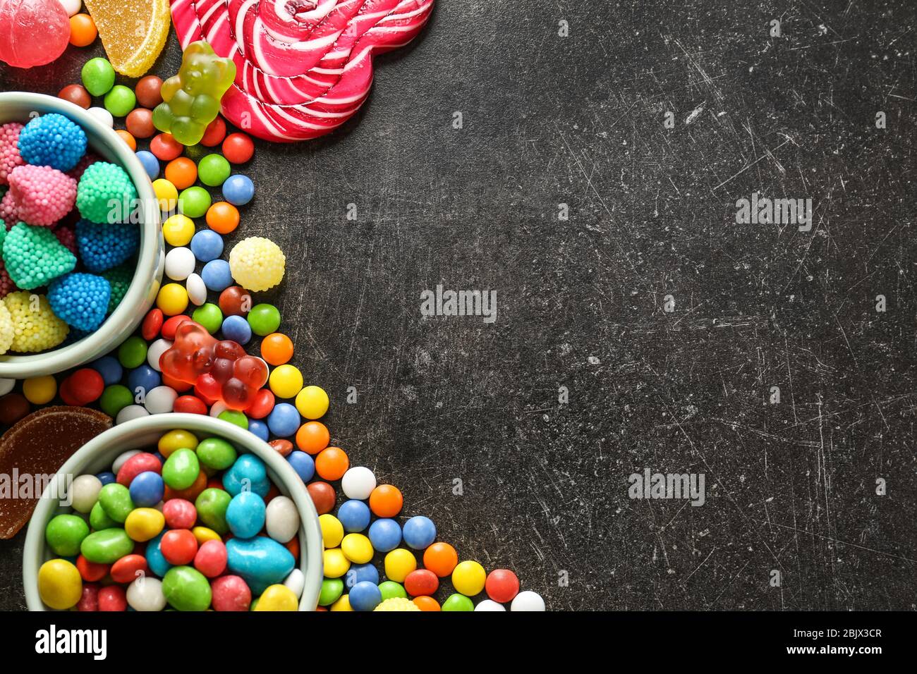 Colorful candies on grey background, flat lay Stock Photo - Alamy