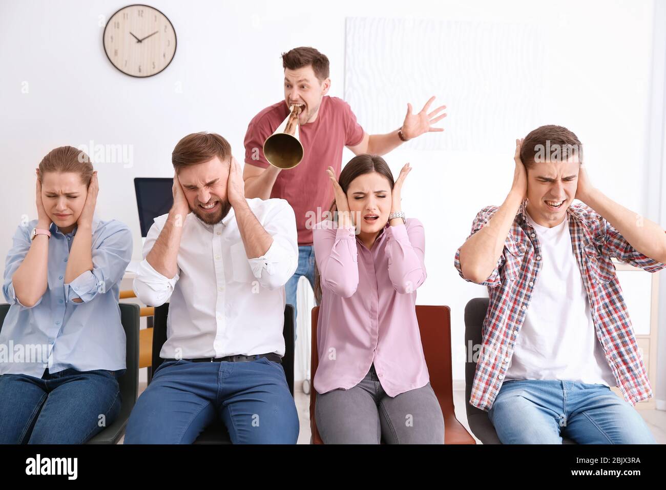 Angry boss with megaphone screaming at employees in office Stock Photo ...