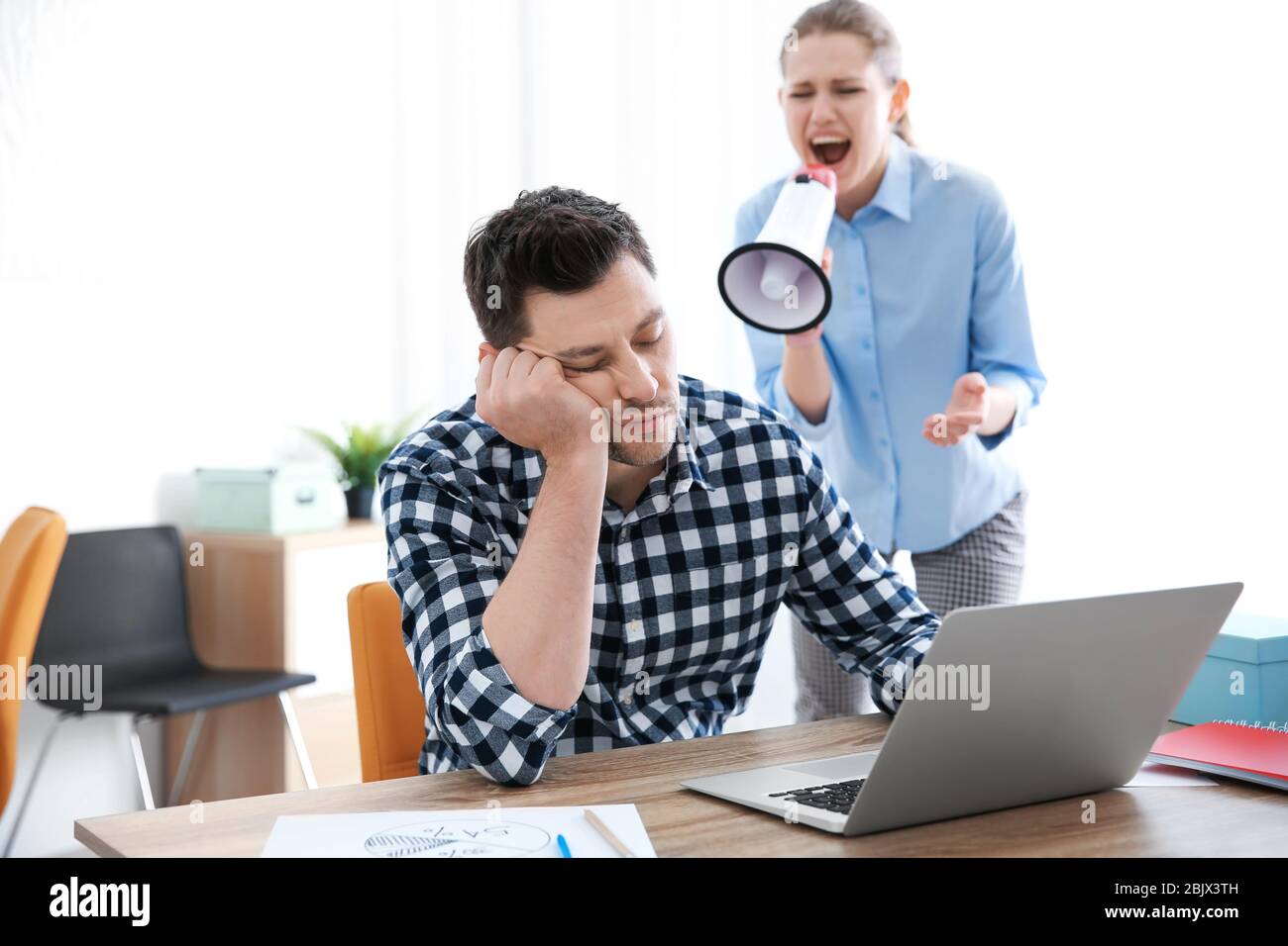 Angry boss with megaphone screaming at sleeping employee in office ...