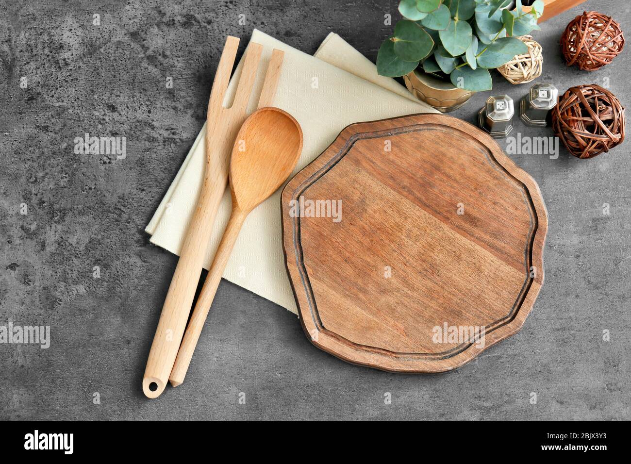 Wooden cooking utensils on grey background Stock Photo - Alamy