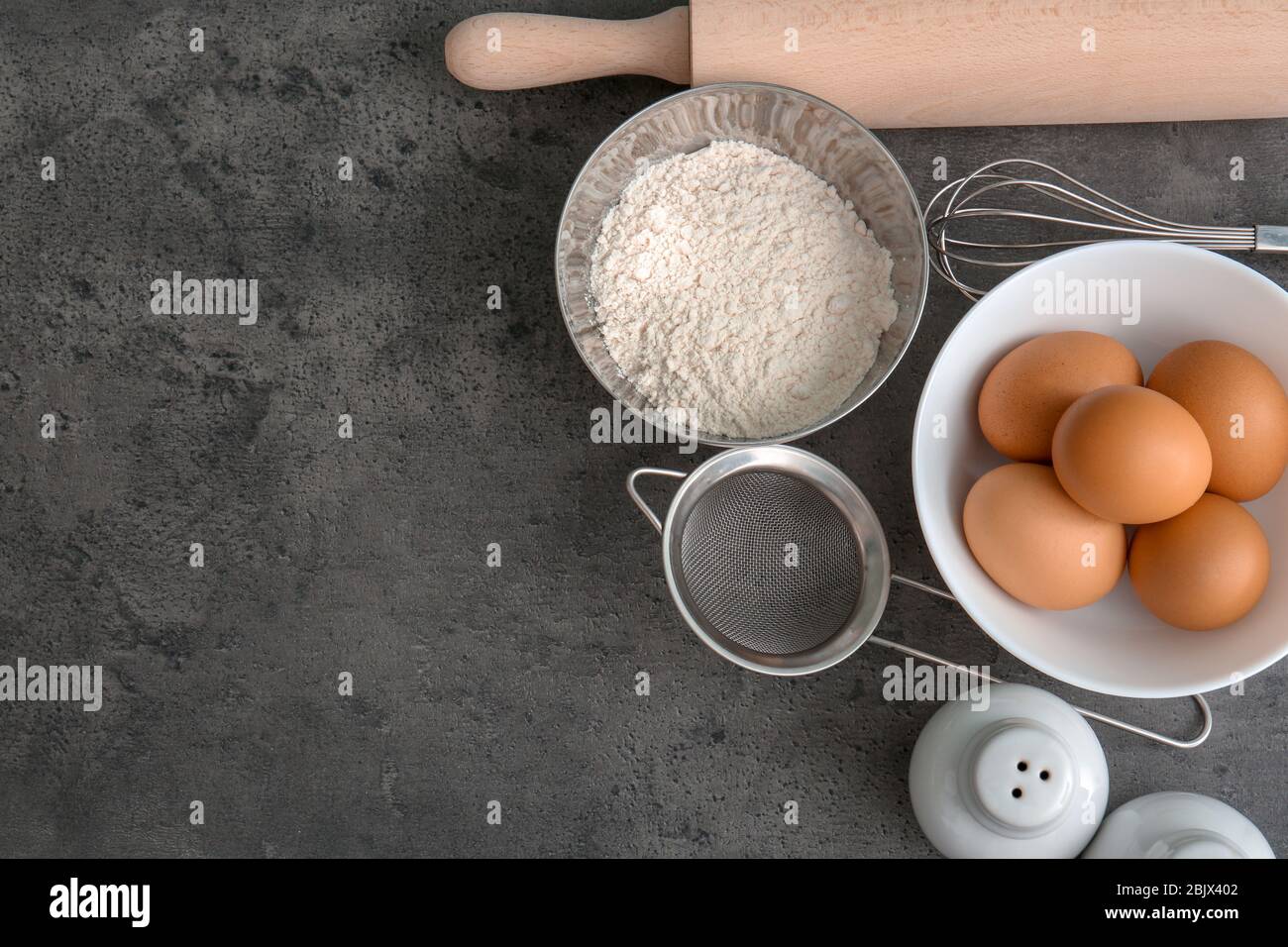 Cooking utensils and products on grey background Stock Photo - Alamy