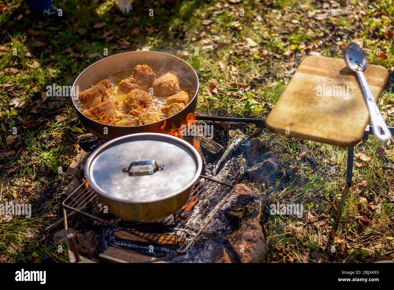 Cooking food over open fire while camping on an adventure Stock Photo ...
