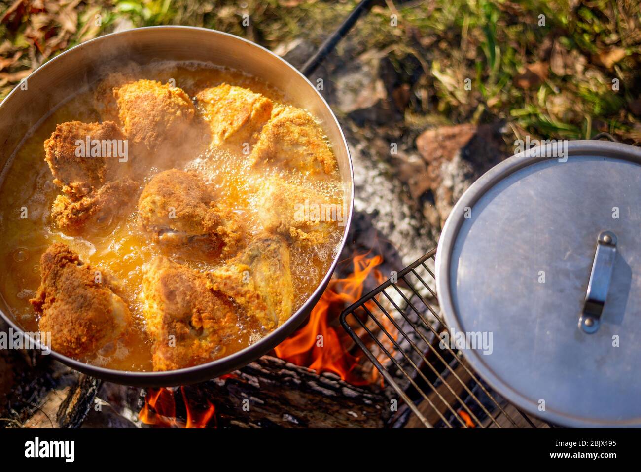 Cooking food over open fire while camping on an adventure Stock Photo ...