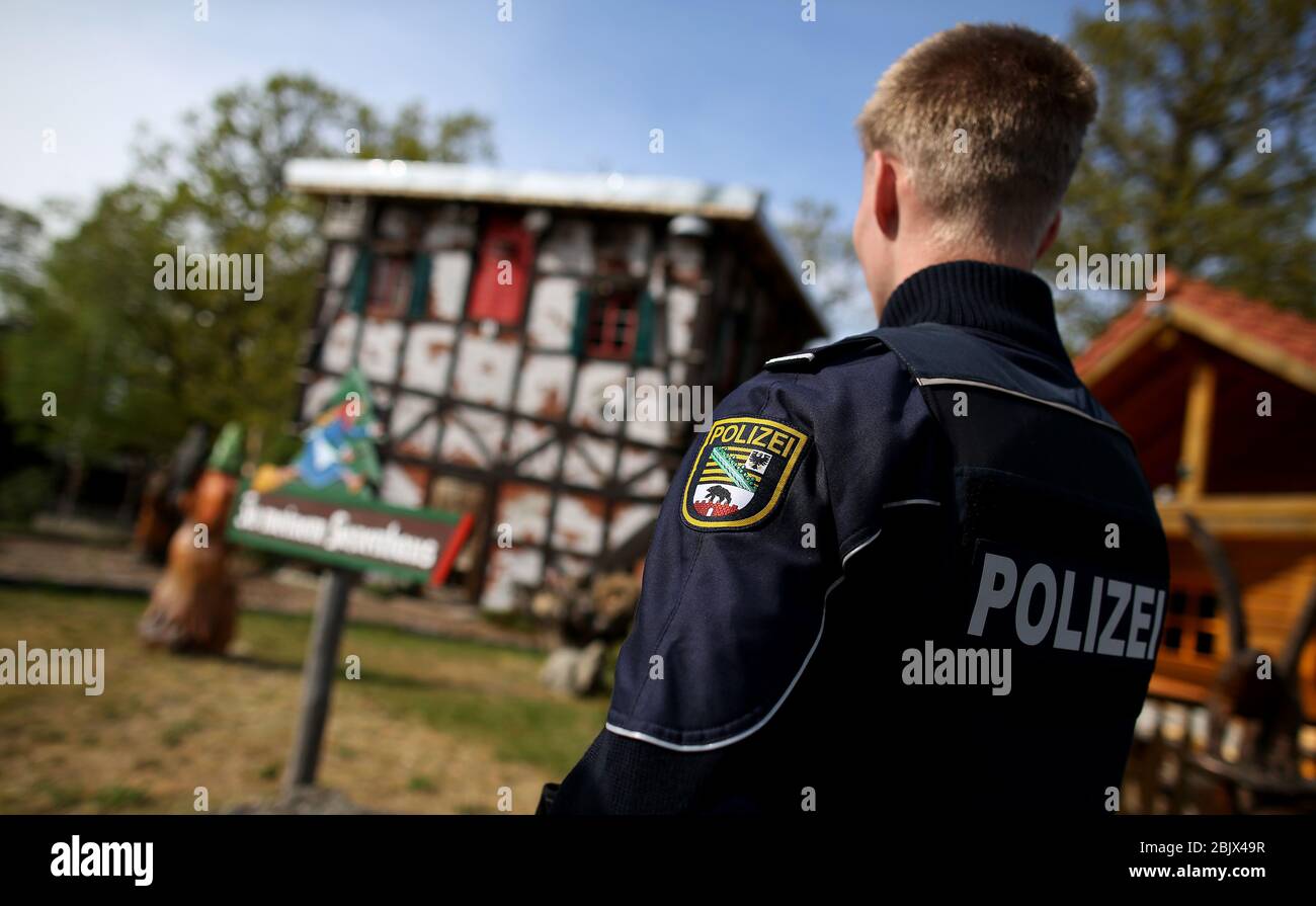 Thale, Germany. 30th Apr, 2020. A police officer patrols the witches ...