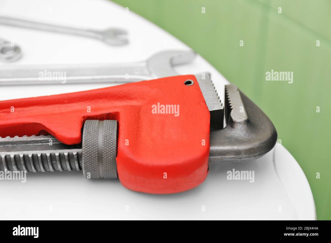 Plumber's tools on toilet seat lid indoors Stock Photo - Alamy
