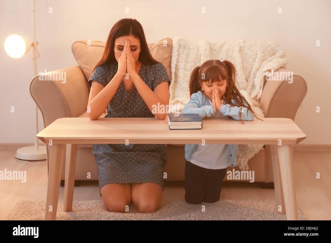 Religious Christian girl and her mother praying at home Stock Photo - Alamy