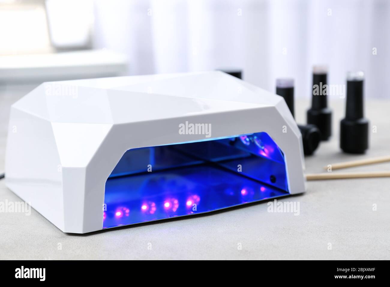 Ultraviolet lamp for manicure on table Stock Photo - Alamy
