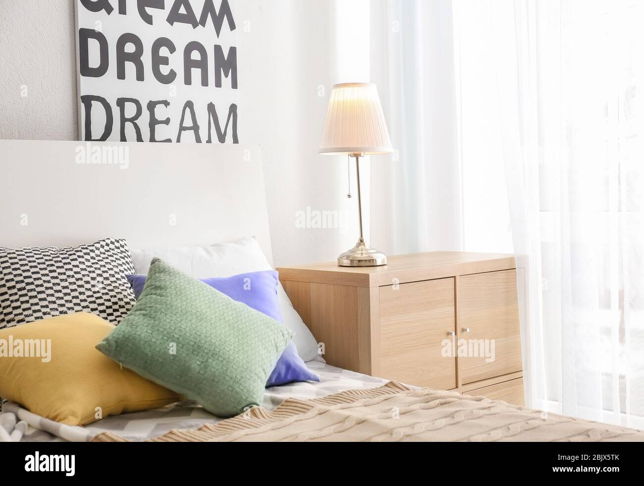 Bedroom interior with elegant table lamp Stock Photo - Alamy