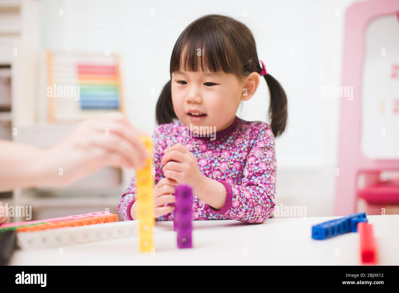 toddler girl play number blocks for homeschooling Stock Photo - Alamy