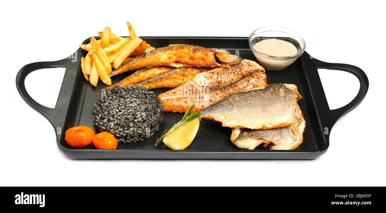 Delicious fried fish platter with garnish on white background Stock ...