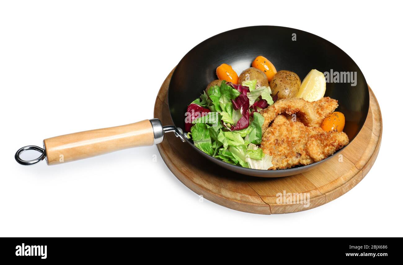 Frying pan with delicious fish fillets and vegetables on white ...