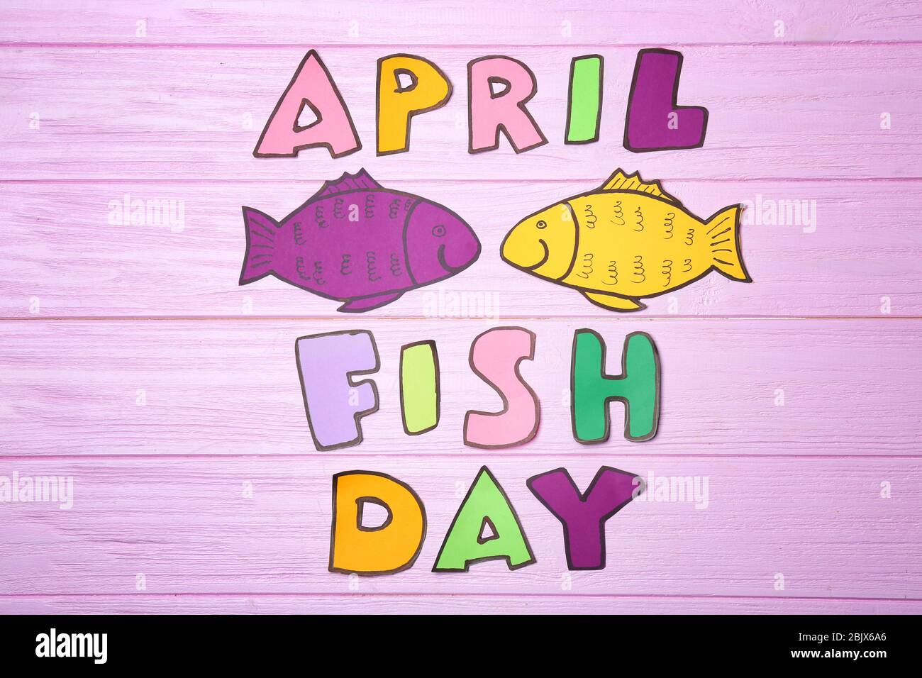 Paper fish and phrase "April fish day" on color background Stock Photo ...