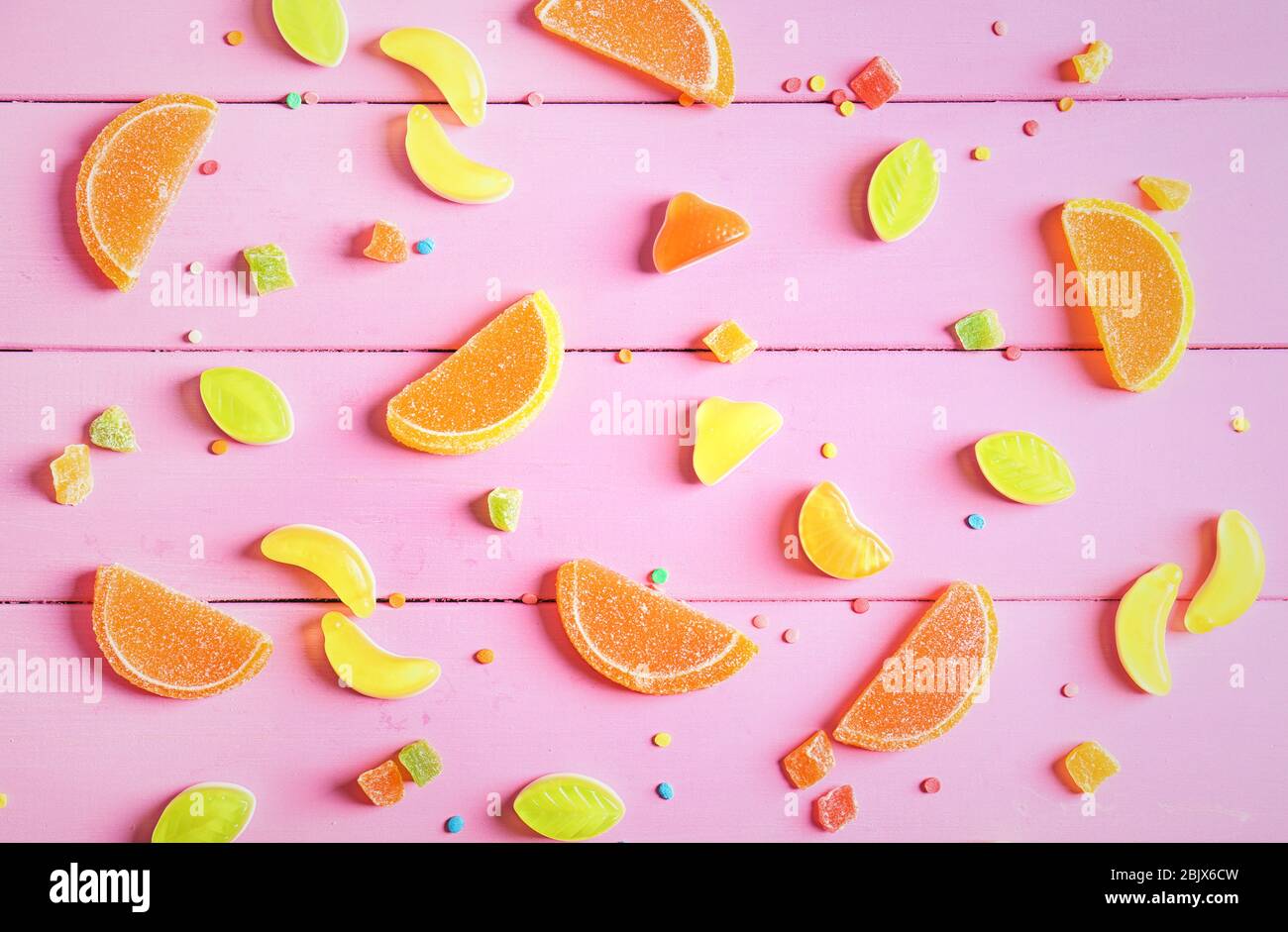 Colorful chewy candies on wooden background, flat lay Stock Photo - Alamy