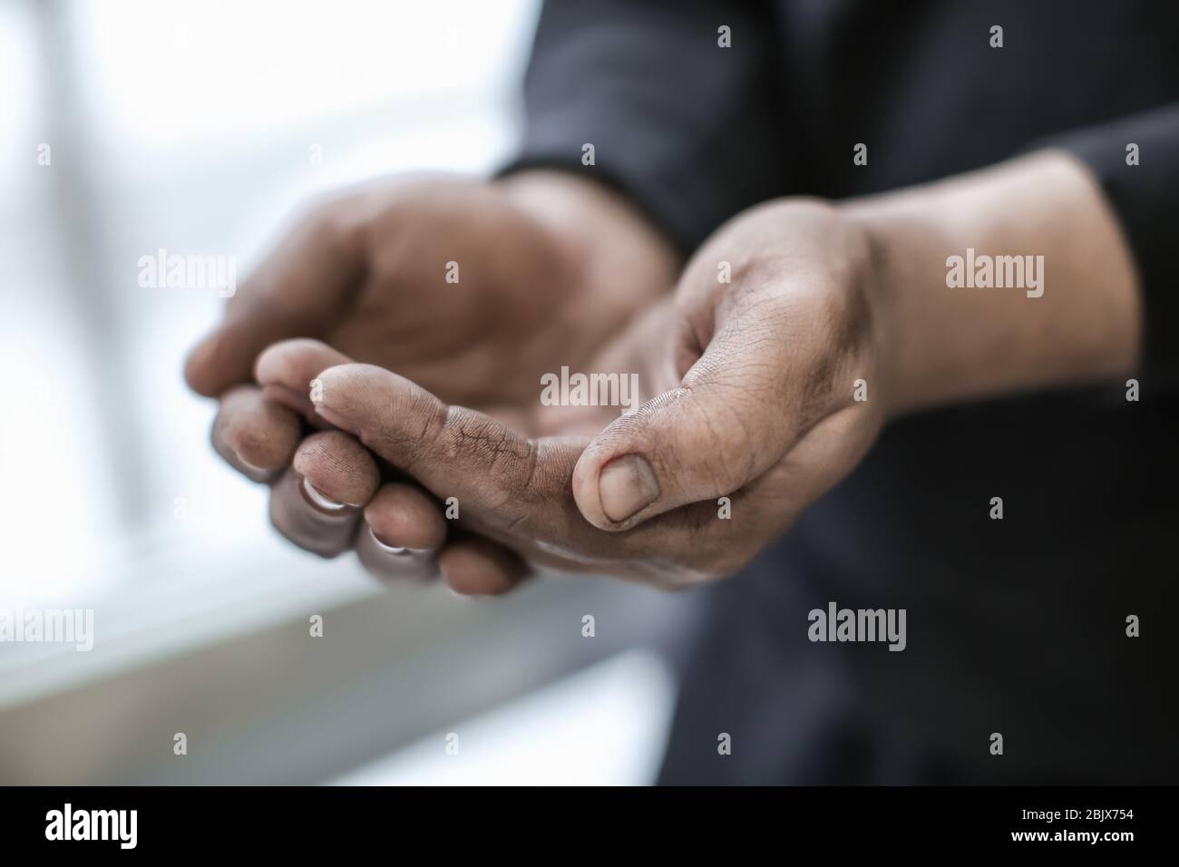 Poor man begging for money, closeup Stock Photo - Alamy