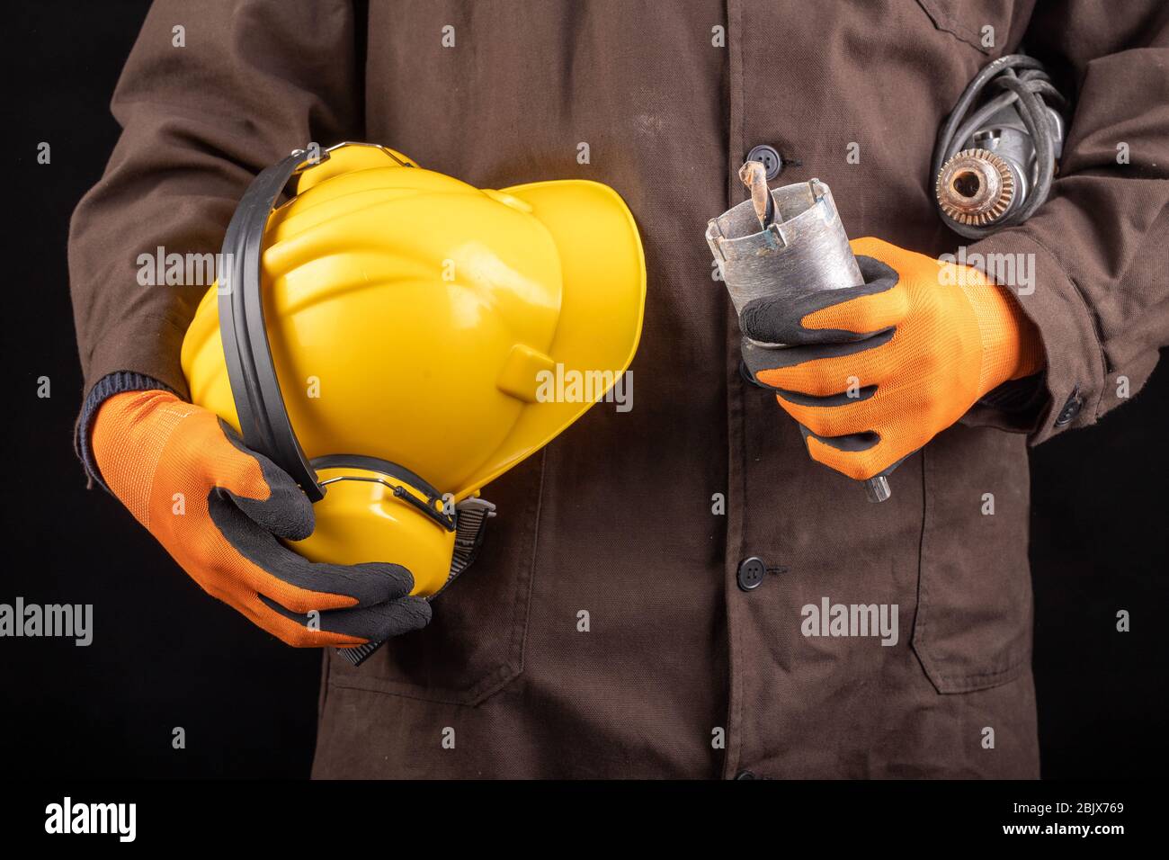 Production worker with drill and drill in hand. Builder with tools ...