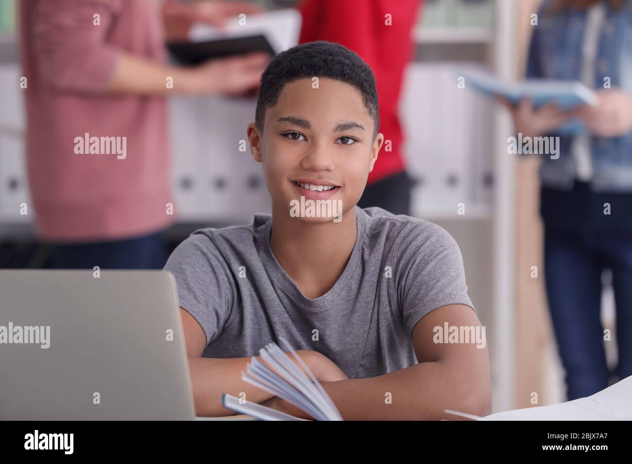 African American teenage boy doing homework, indoors Stock Photo - Alamy