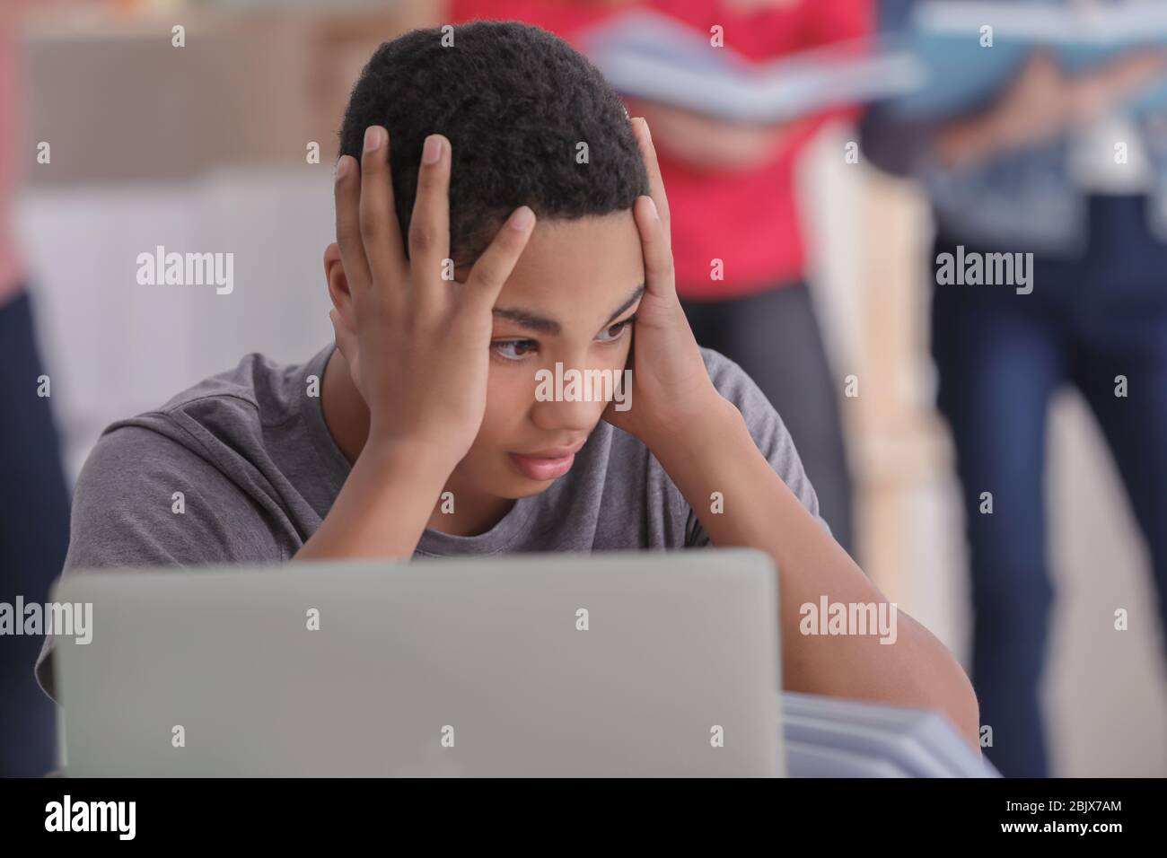 African American teenage boy doing homework, indoors Stock Photo - Alamy