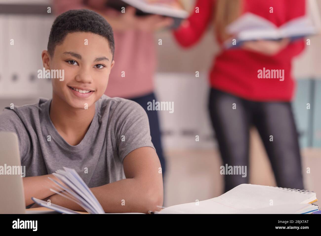 African American teenage boy doing homework, indoors Stock Photo - Alamy