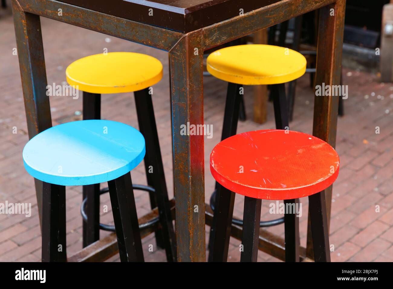 picture of bar stools with different colors at an outdoor cafe Stock ...