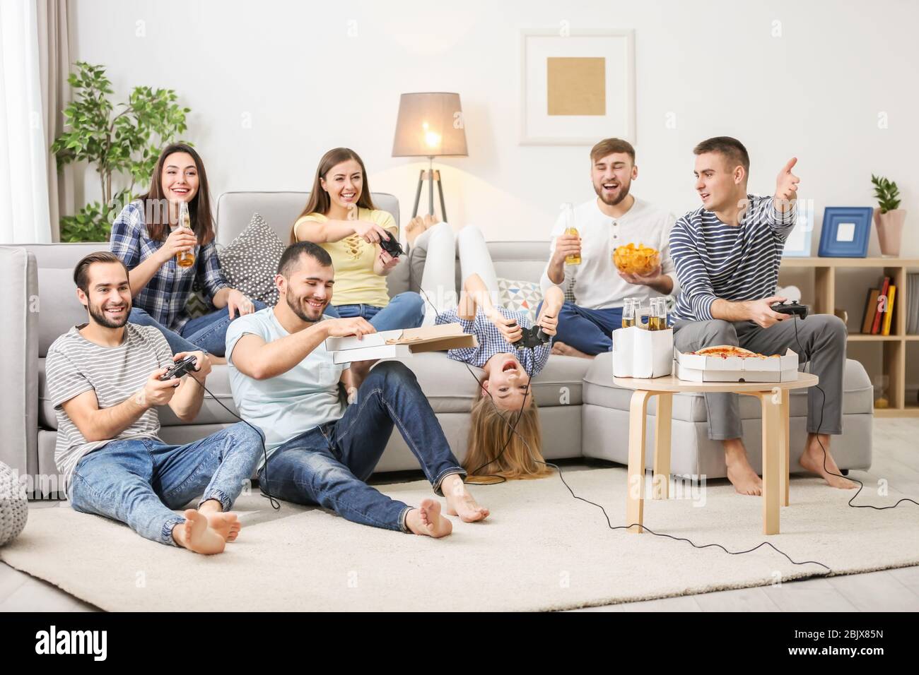 Young people playing video games at home Stock Photo - Alamy