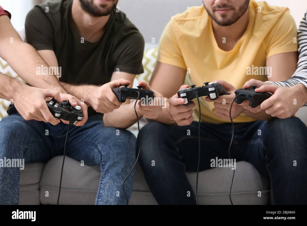 Young men playing video games at home, closeup Stock Photo - Alamy